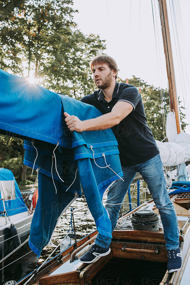 "Man Preparing Boat For Sailing" by Stocksy Contributor "Sergey ...