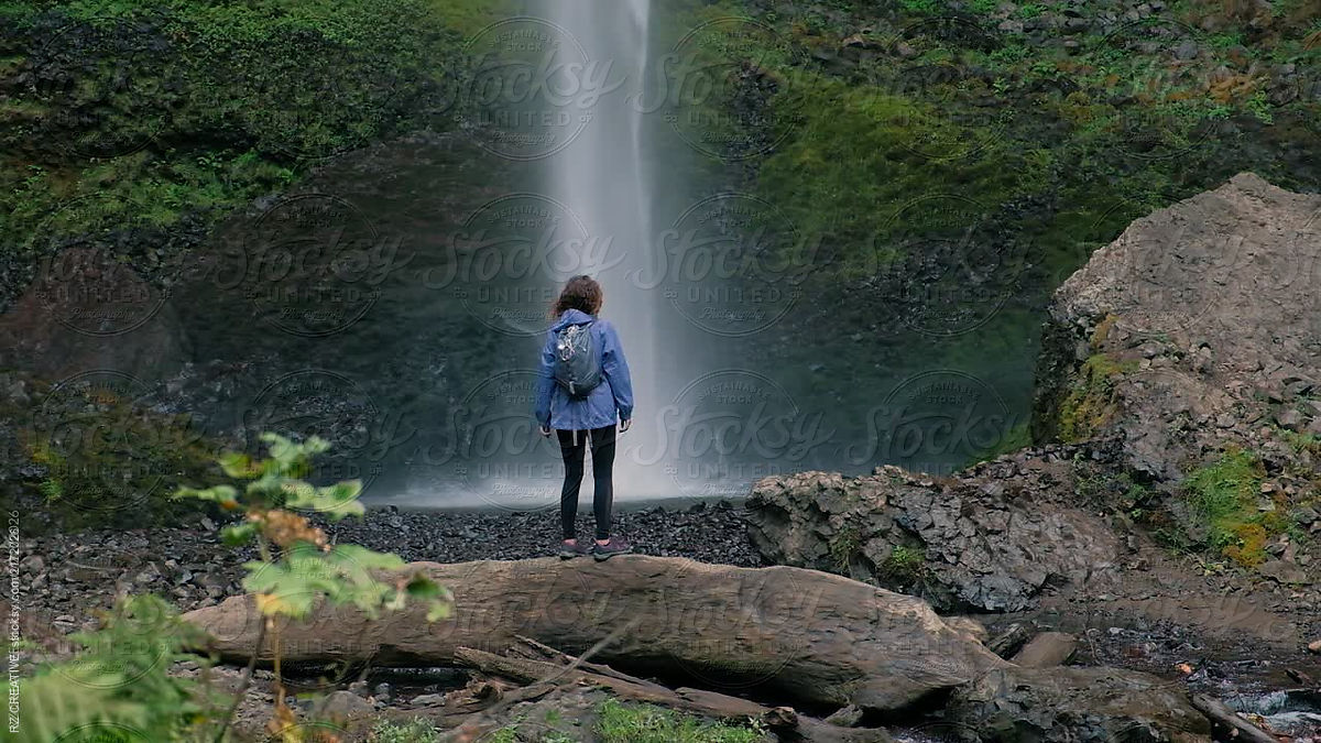 "Woman Watching Large Waterfall" by Stocksy Contributor "RZCREATIVE ...