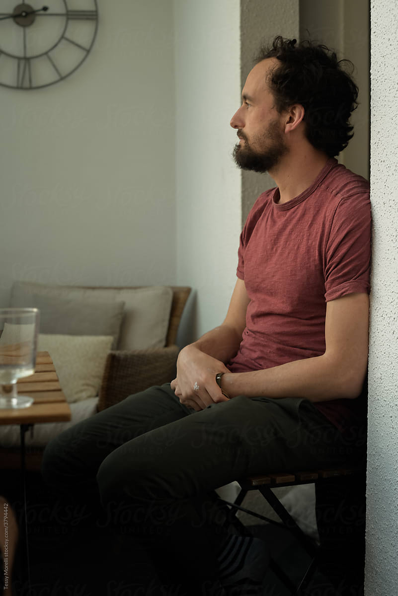 "Man Looking Outside With An Empty Glass" by Stocksy Contributor "tessy ...