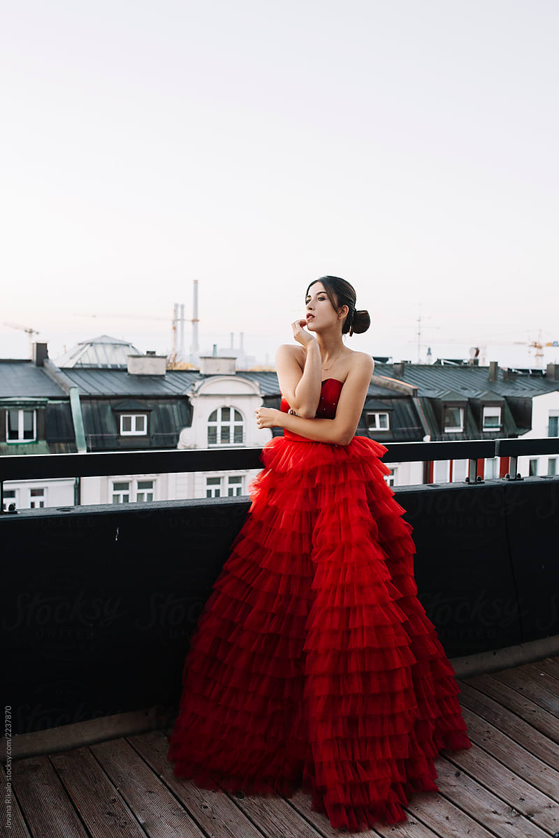 "Young Woman In A Red Dress On The Balcony" by Stocksy Contributor ...