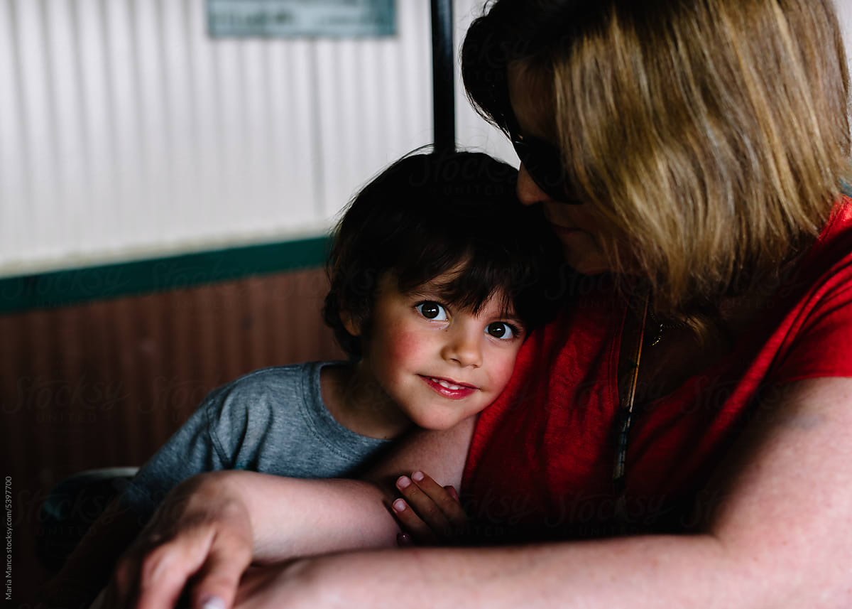 "Boy Leans On Grandma's Arm" by Stocksy Contributor "Maria Manco" - Stocksy