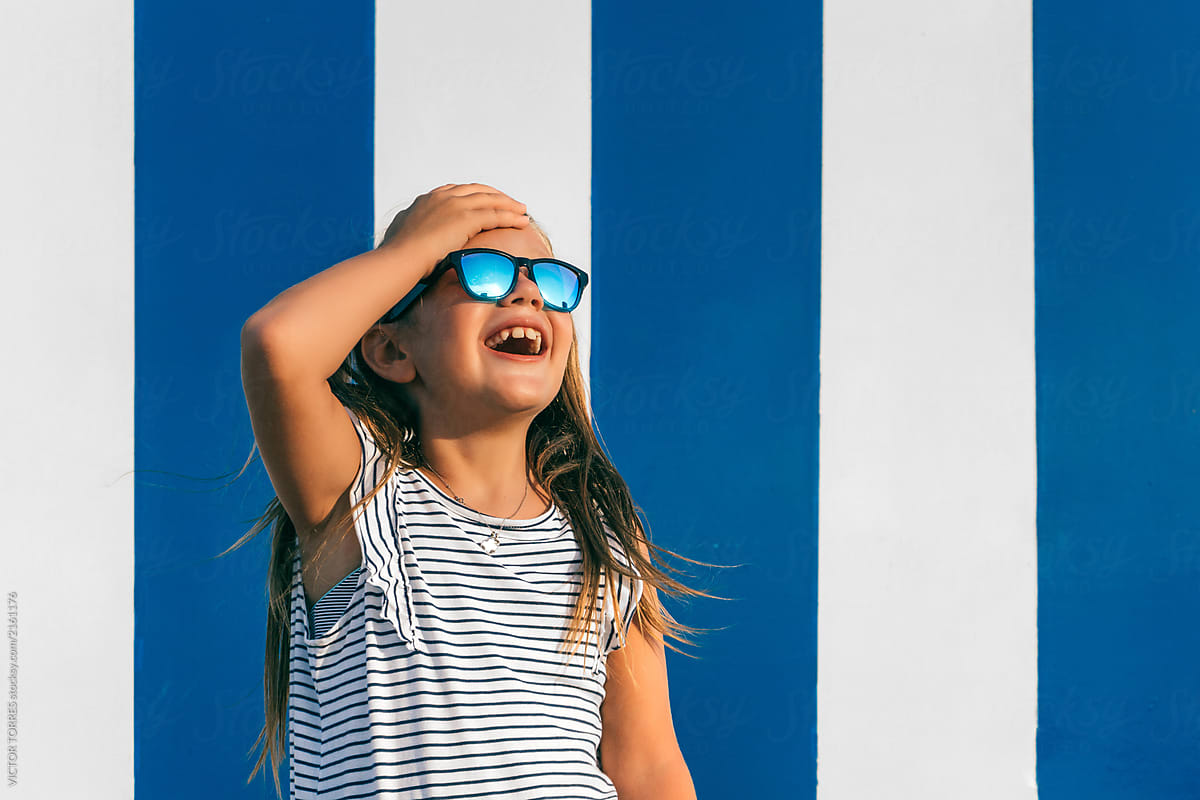 "Cute Girl Laughing With Hand On Face." by Stocksy Contributor "VICTOR ...