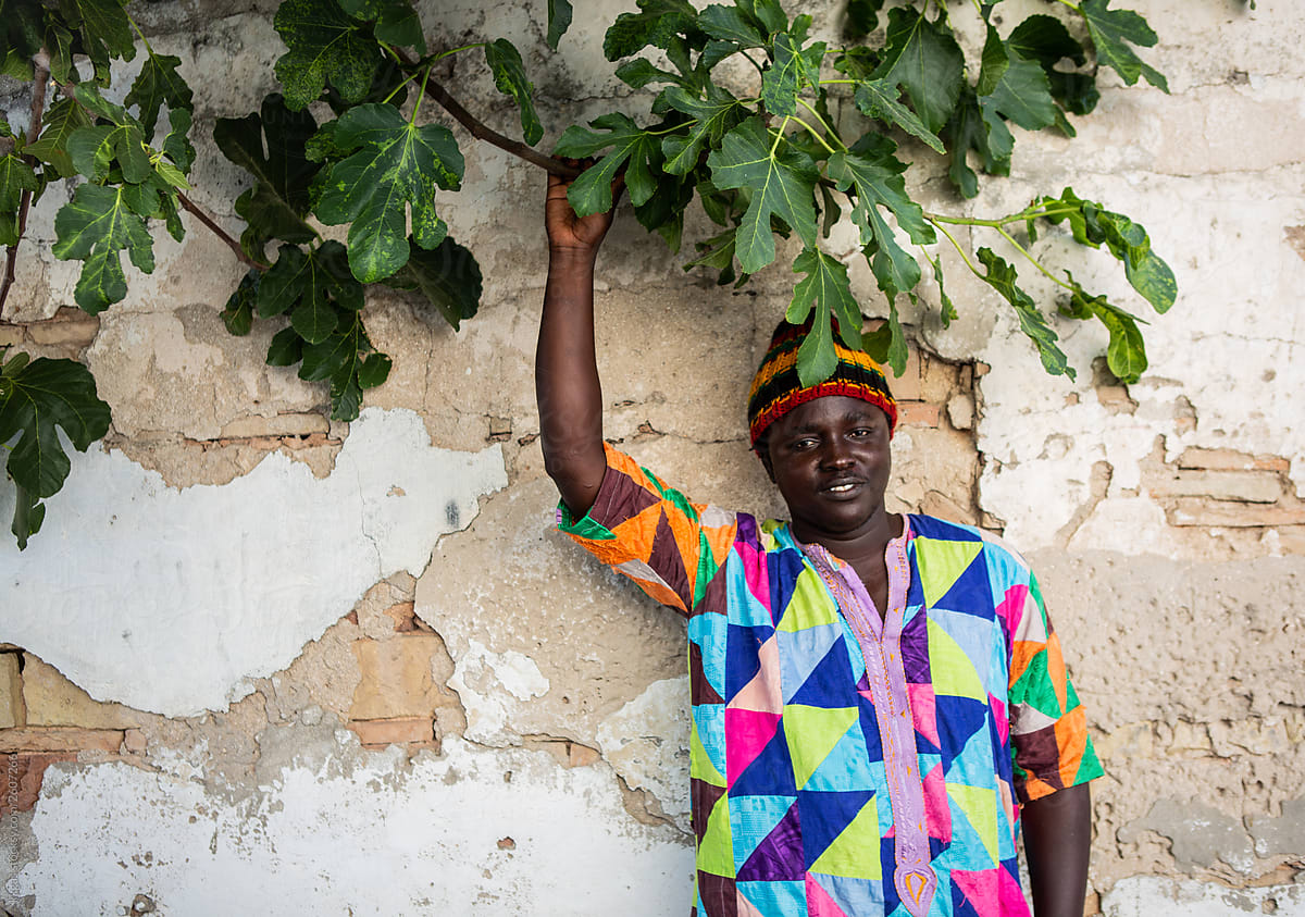 "Man Reaching For Fig Tree Branch" by Stocksy Contributor "kkgas" - Stocksy