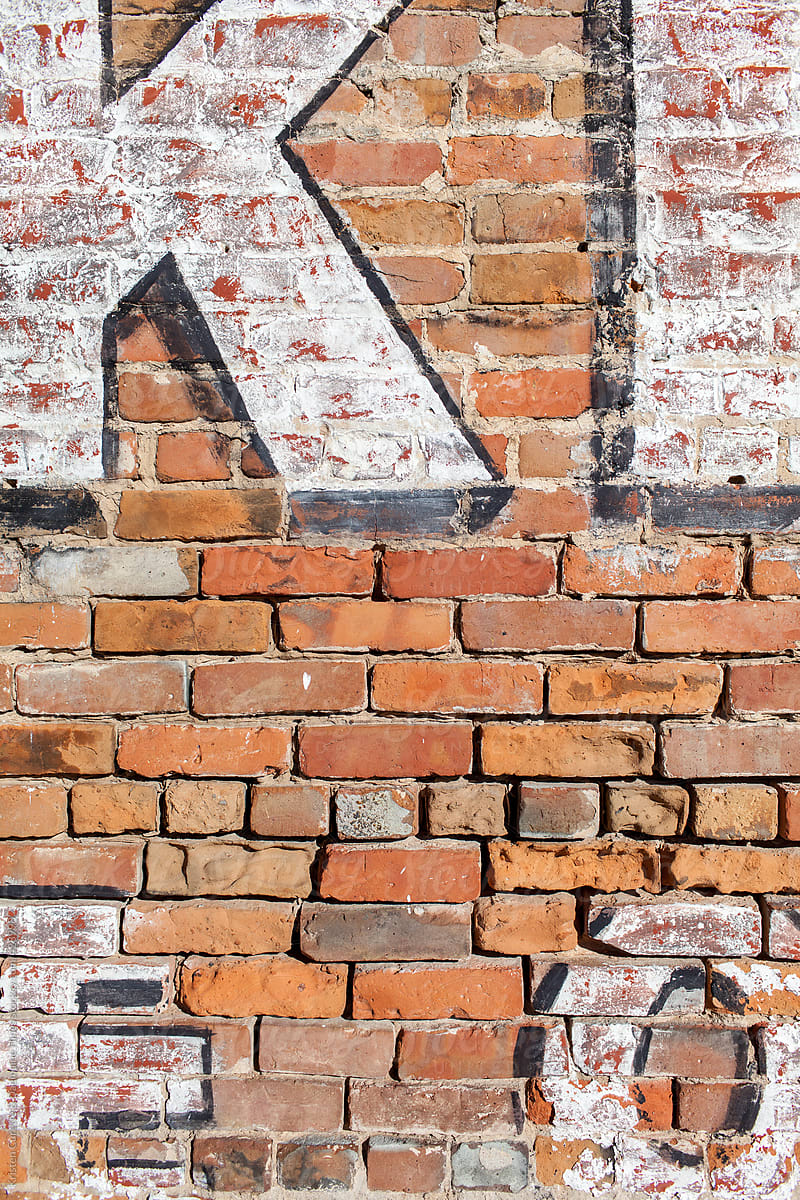 "Brick Wall With Lettering" by Stocksy Contributor "Kristen Curette ...