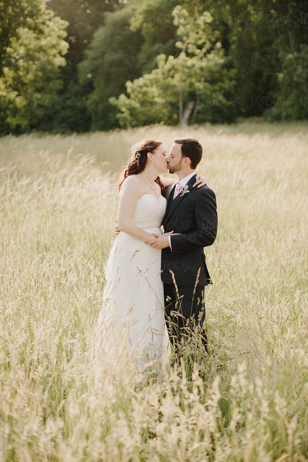 "Couple Kissing In Field" by Stocksy Contributor "Sidney Scheinberg ...