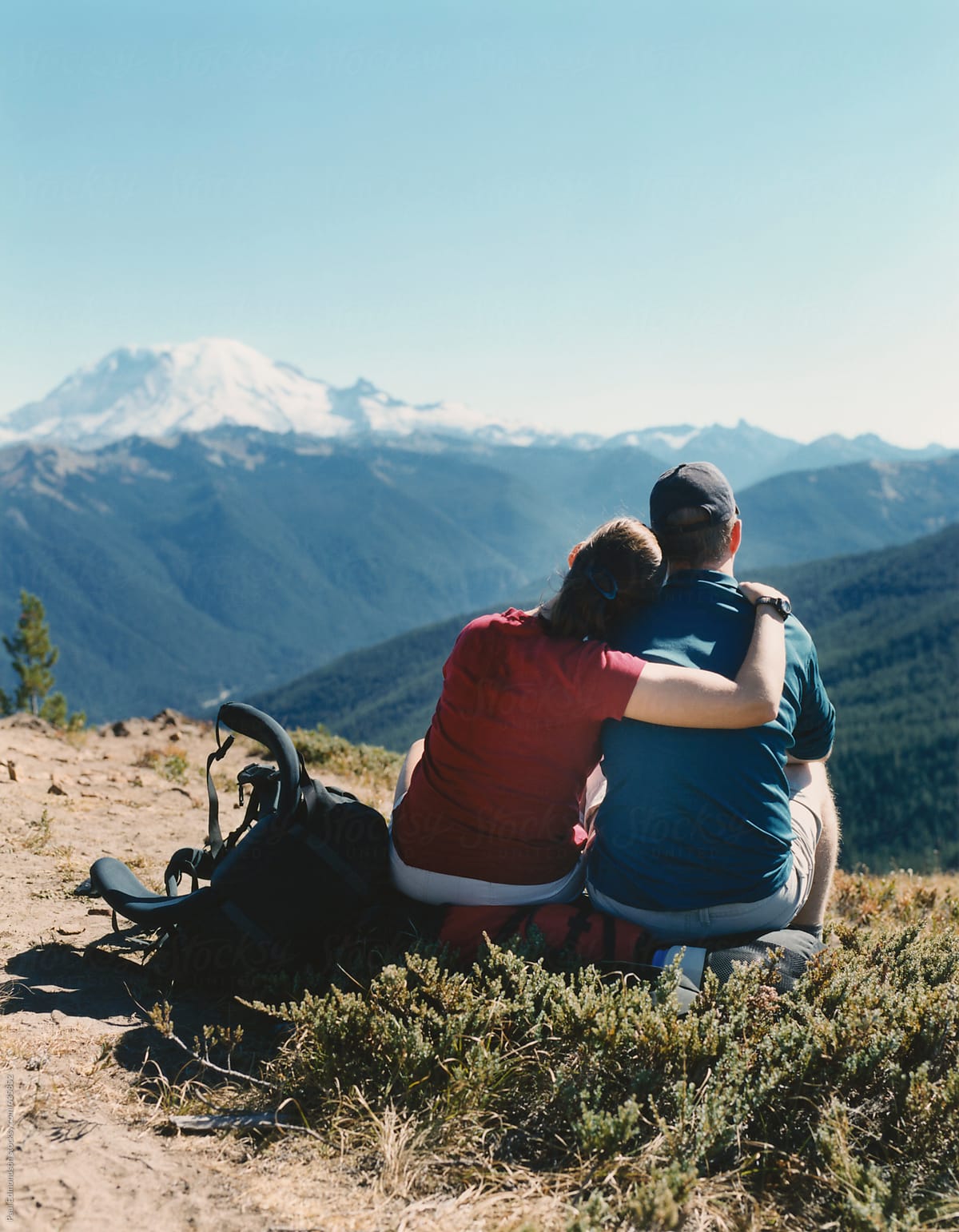 "Couple Resting On Hiking Trail, Taking In View Of Mt. Rainier" by ...