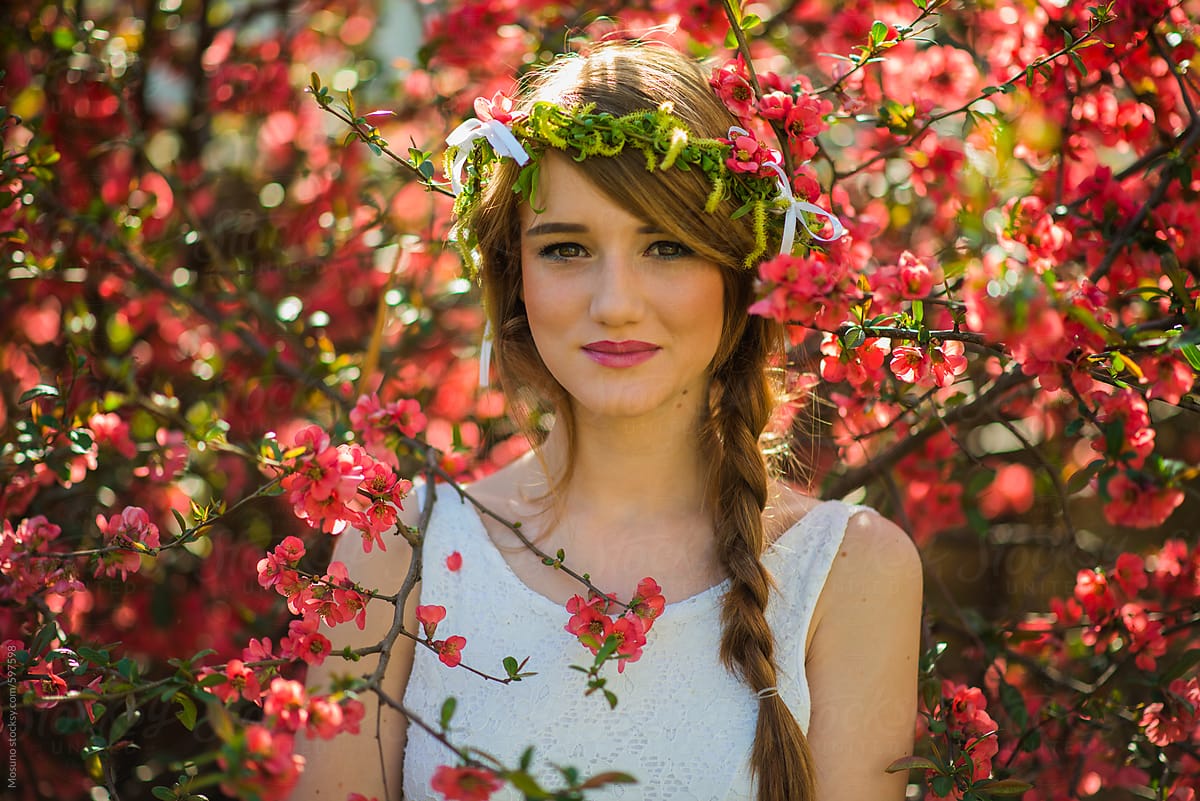 "Woman Posing In Spring Flowers" by Stocksy Contributor "Mosuno" - Stocksy