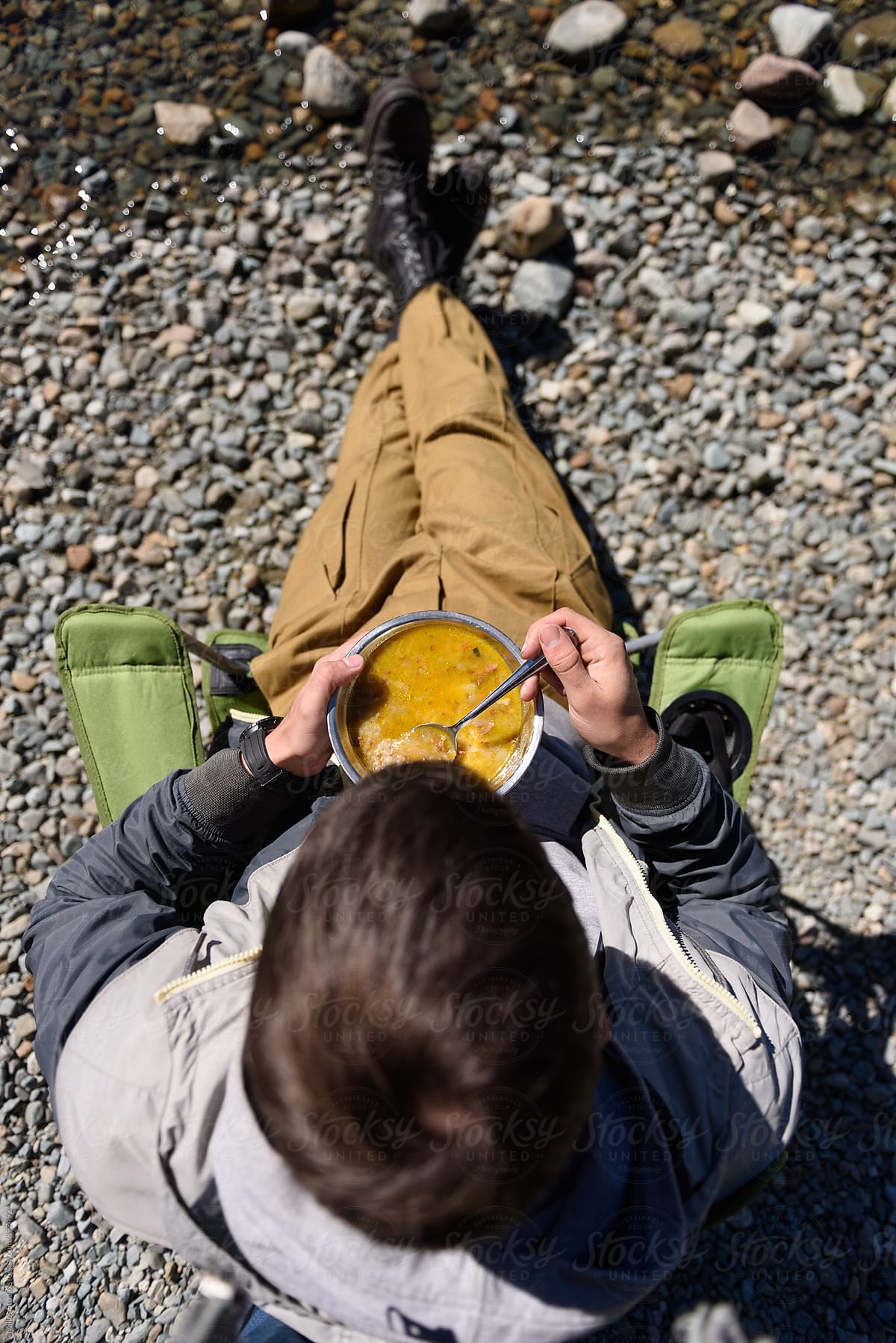 "Man Eating Soup" by Stocksy Contributor "Milles Team" - Stocksy