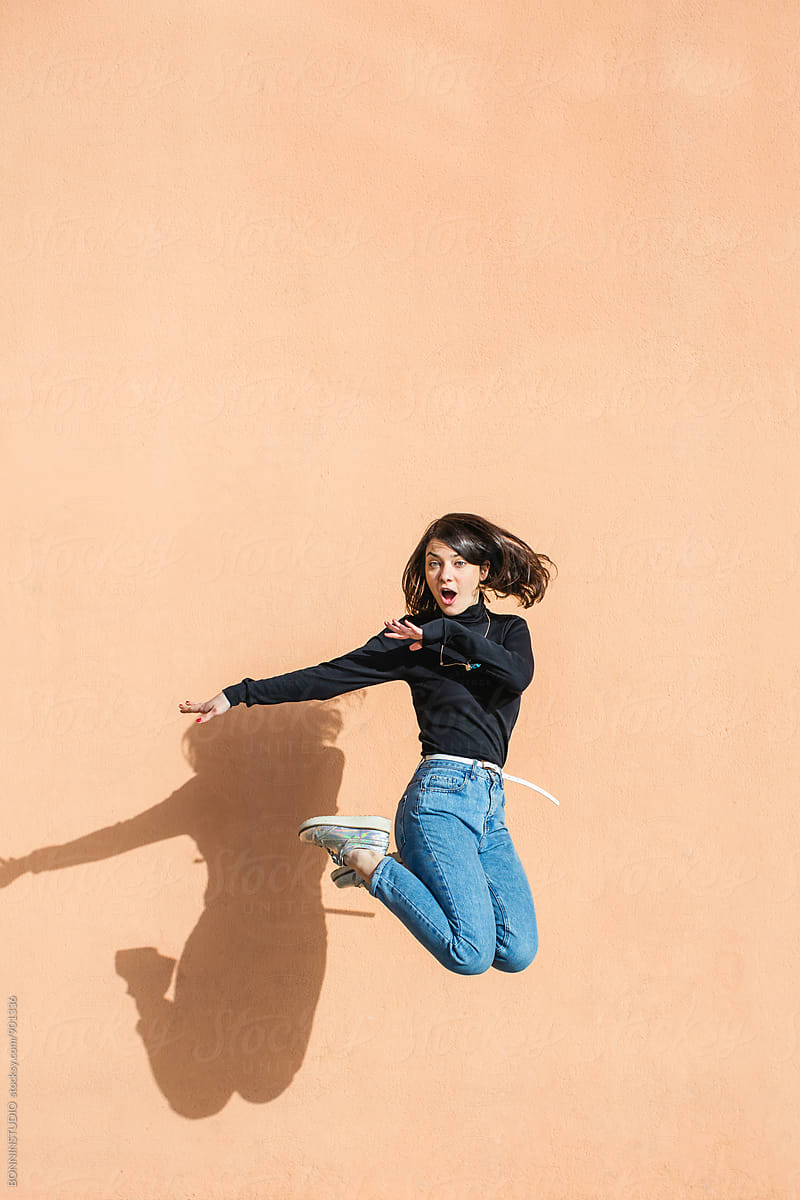 "Brunette Girl Jumping In Front Of A Wall." by Stocksy Contributor ...