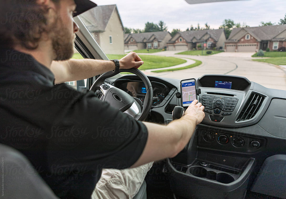 "Shipping: Delivery Man Uses Cell Phone For Directions" by Stocksy ...