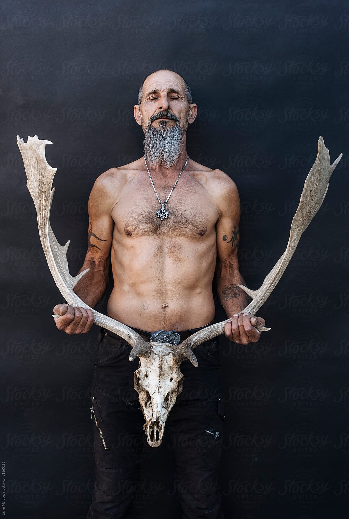 "Skull Held By A Tattooed Aged Man" by Stocksy Contributor "Javier ...