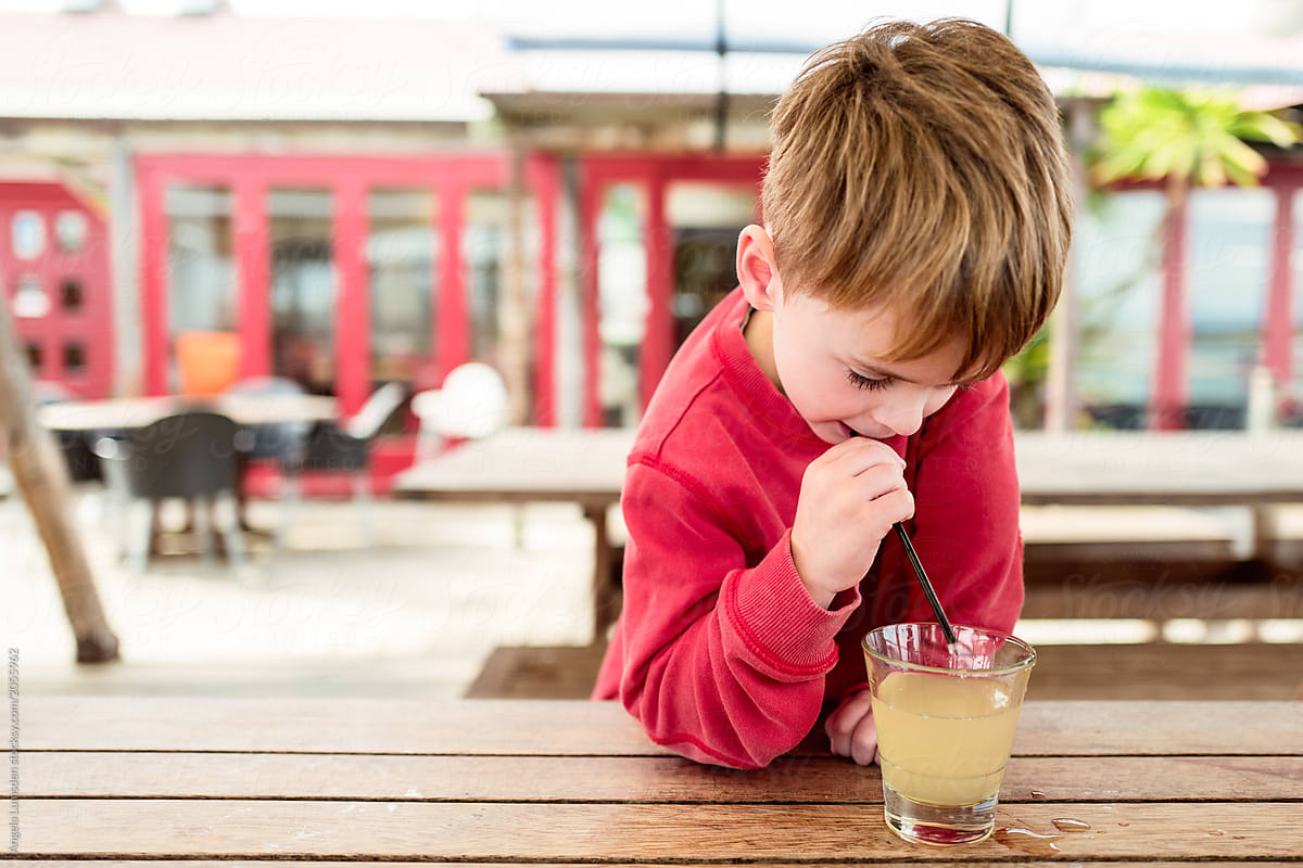 "Boy With Apple Juice At An Outdoor Table" by Stocksy Contributor ...