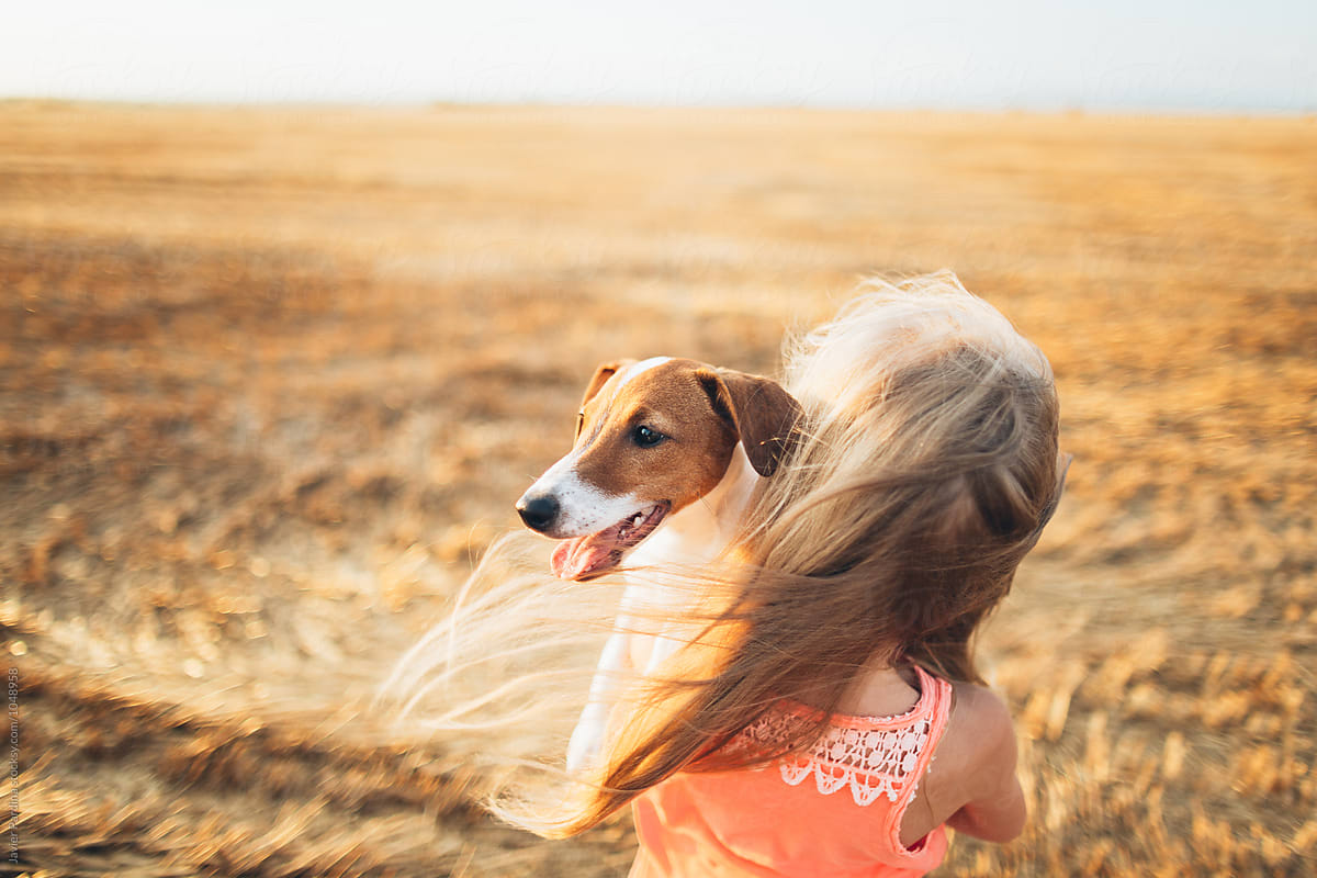 "Child Carrying Dog" by Stocksy Contributor "Pardina Studio x Katya D ...
