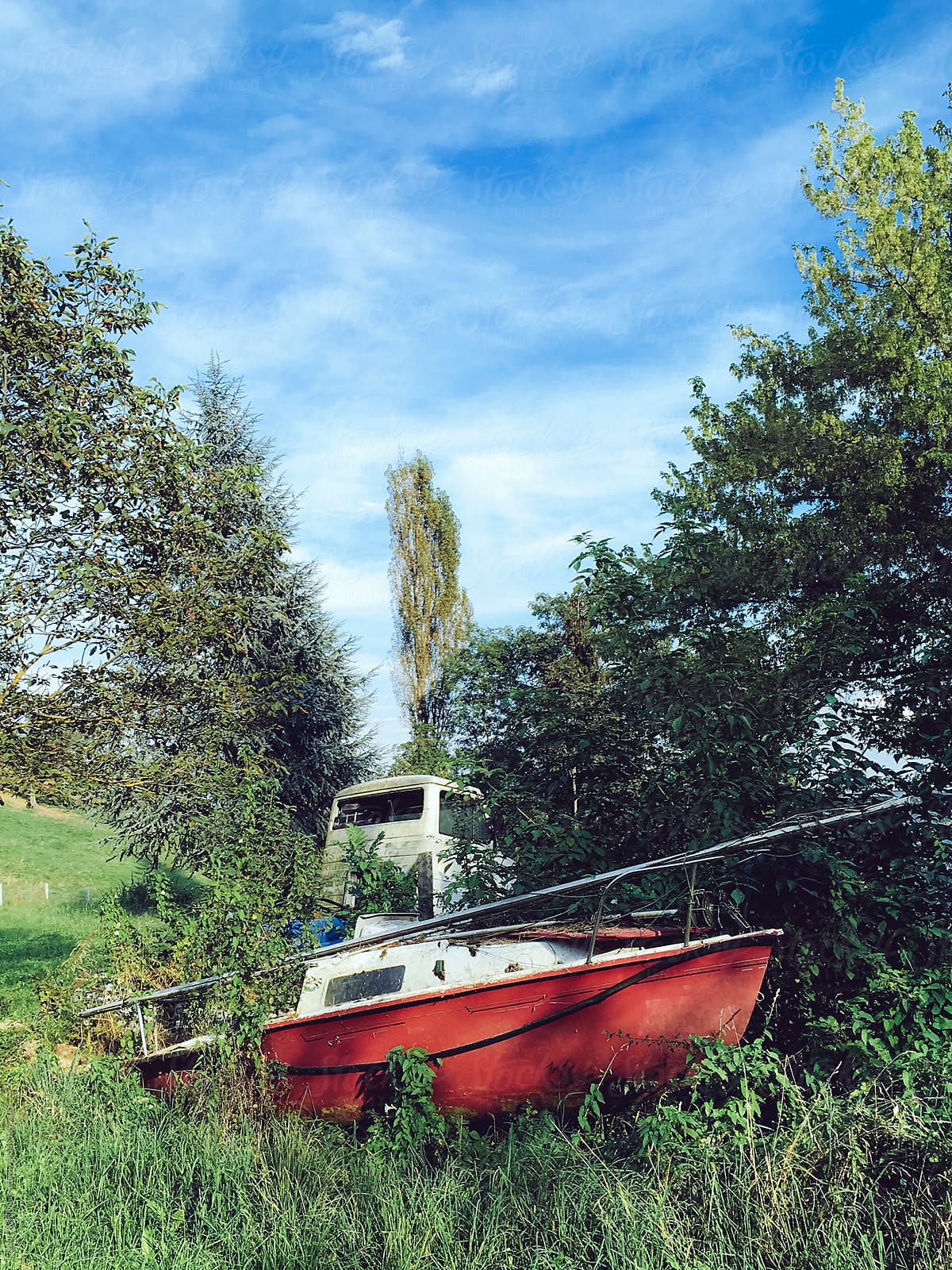 "Old Boat In Meadow" by Stocksy Contributor "Robert Kohlhuber" - Stocksy