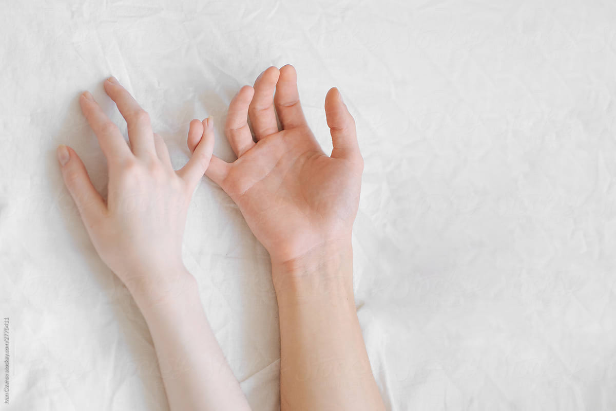 "Two Hands On A White Sheet" by Stocksy Contributor "Ivan Ozerov" - Stocksy