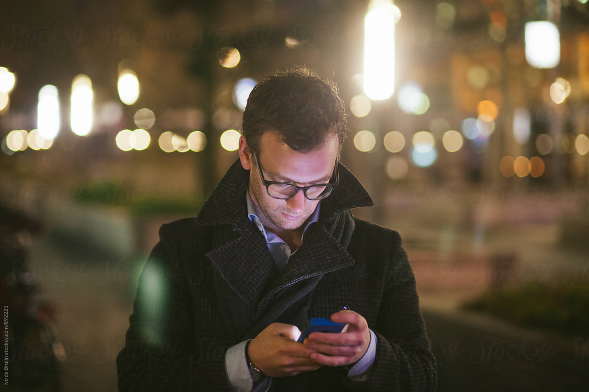 "Young Business Man Looking At His Phone In The Evening" by Stocksy ...
