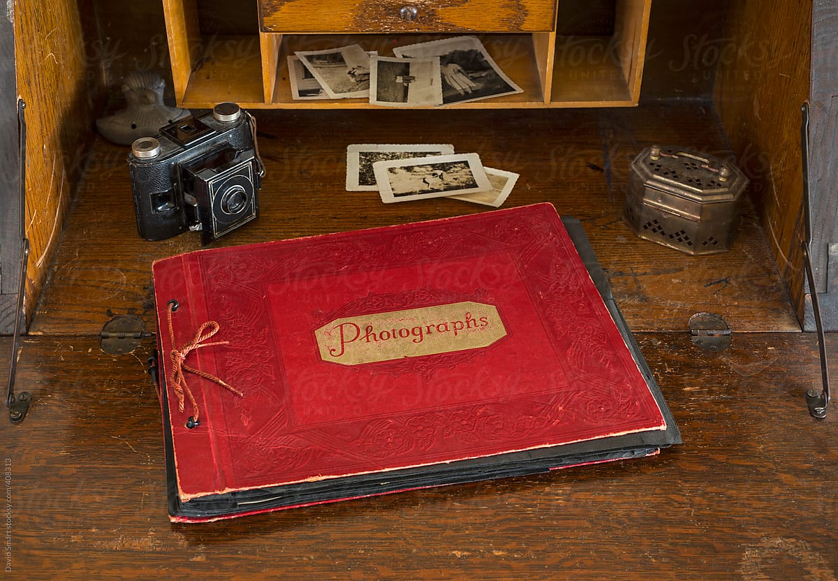 "Old Camera And Photo Album On A Desk" by Stocksy Contributor "David ...