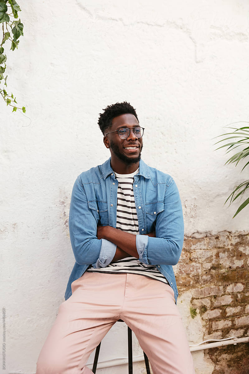 "Relaxed Black Man Sitting Near Wall" by Stocksy Contributor ...