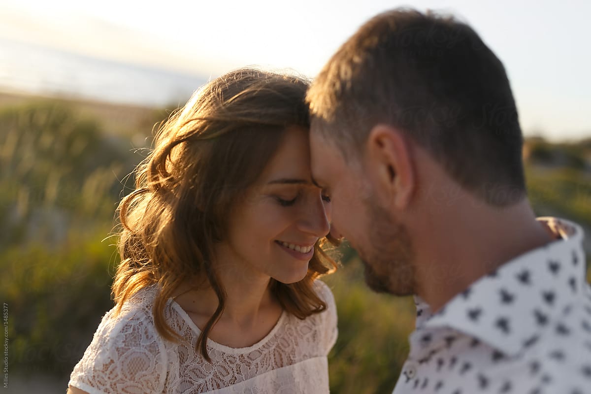 "Lovers Embracing In Field" by Stocksy Contributor "Milles Team" - Stocksy