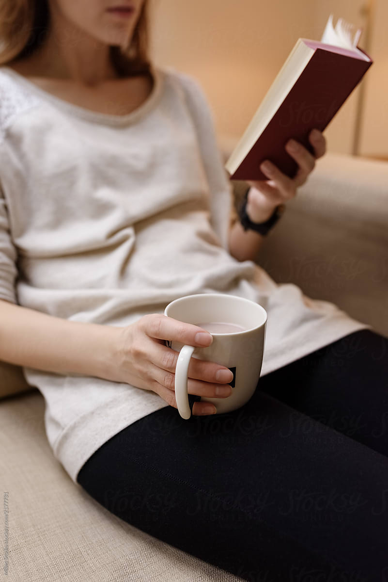 "Crop Woman With Book And Coffee" by Stocksy Contributor "Milles Team ...