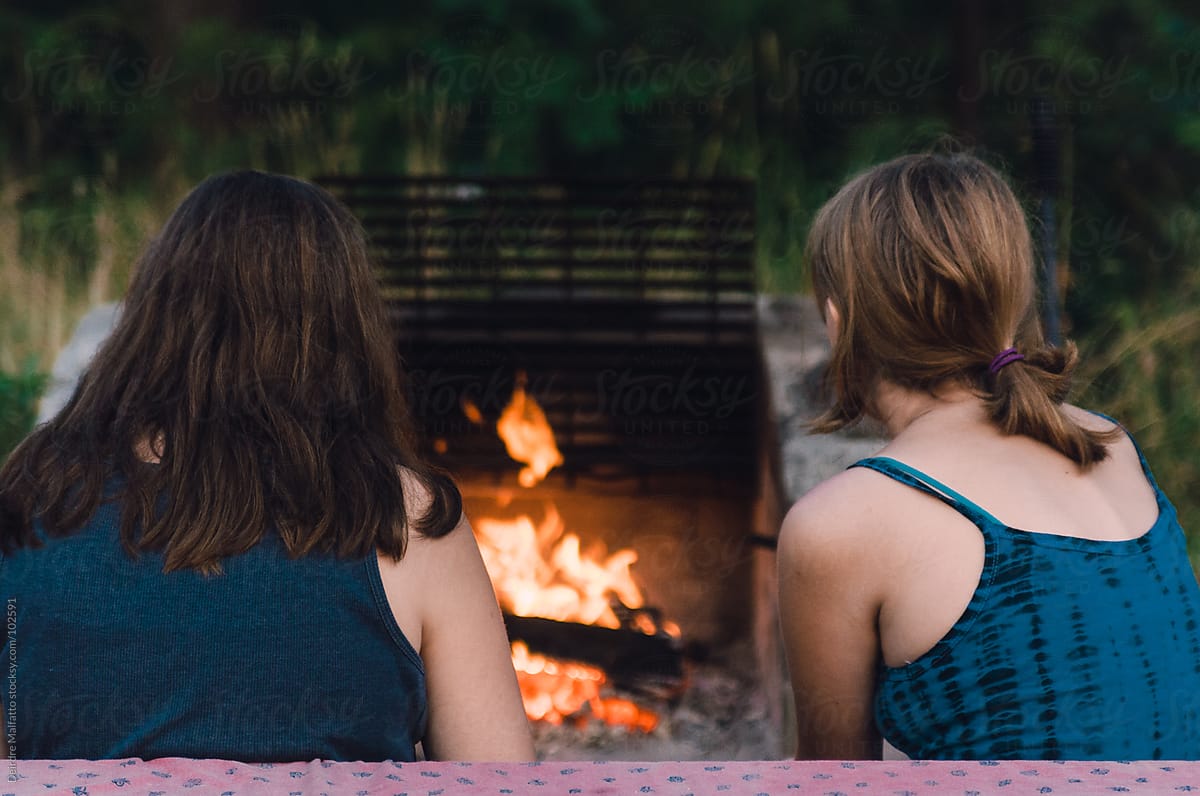 "Two Girls (sisters) Making Music By Camping Fire" by Stocksy ...