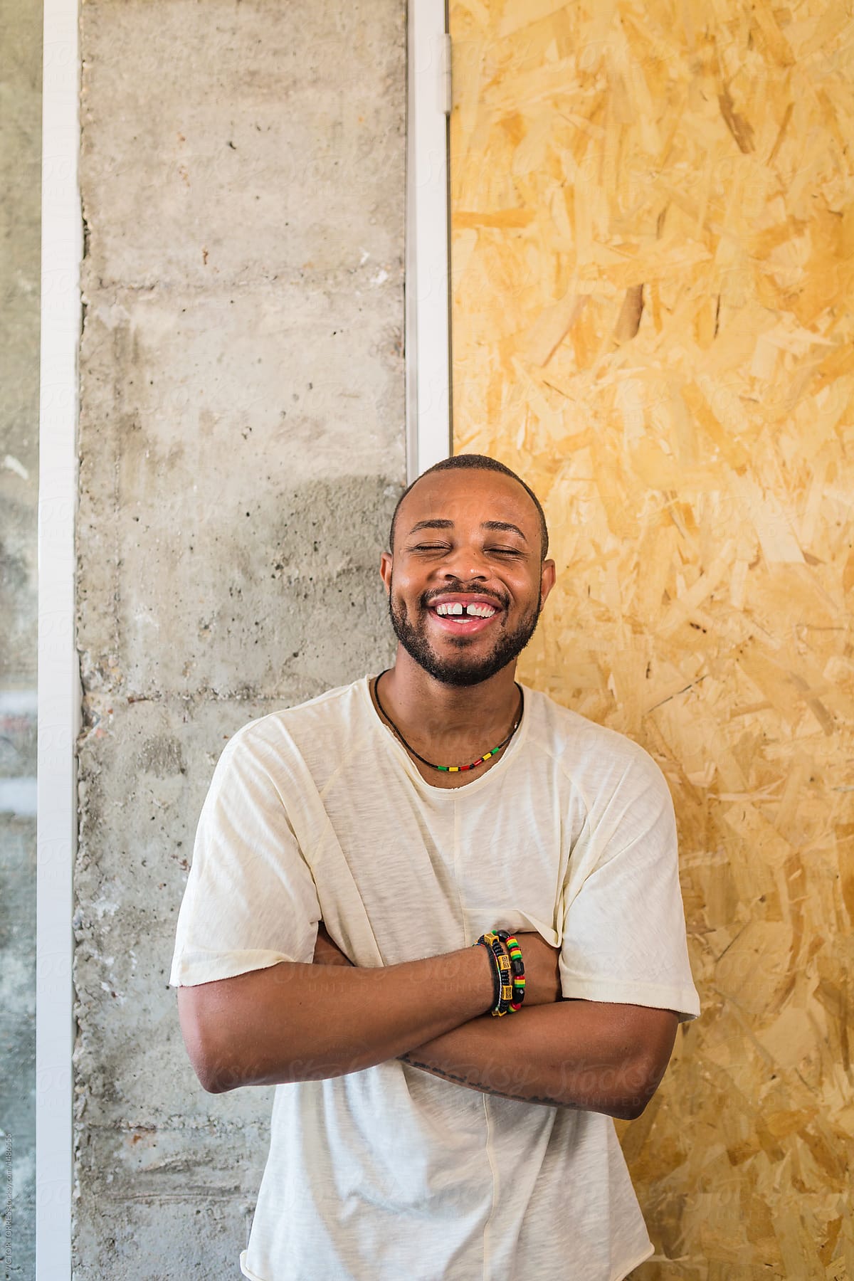 "Laughing Black Man" by Stocksy Contributor "VICTOR TORRES" - Stocksy