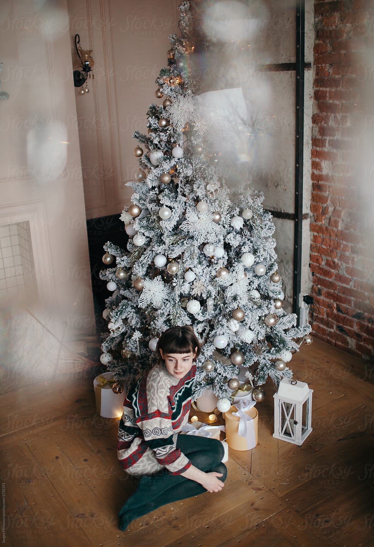 "Young Woman Sitting Near Christmas Tree" by Stocksy Contributor "Serge ...