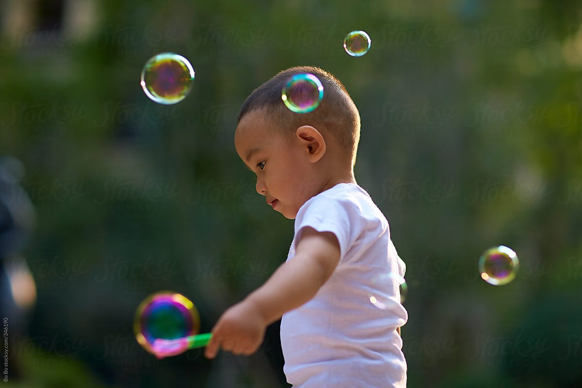 "Little Boy Outdoor With Bubble" by Stocksy Contributor "Bo Bo" - Stocksy
