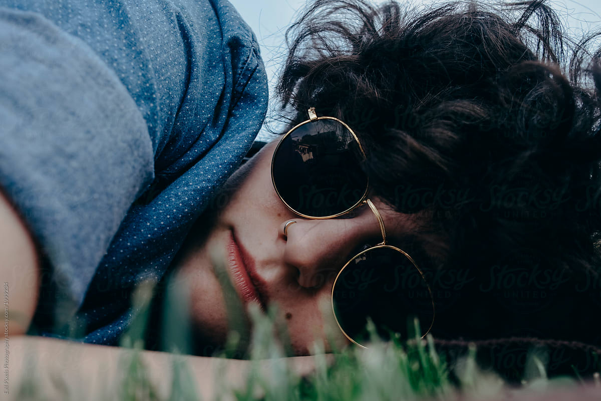 "Close Up Shot Of A Tomboy Lying On The Grass" by Stocksy Contributor ...