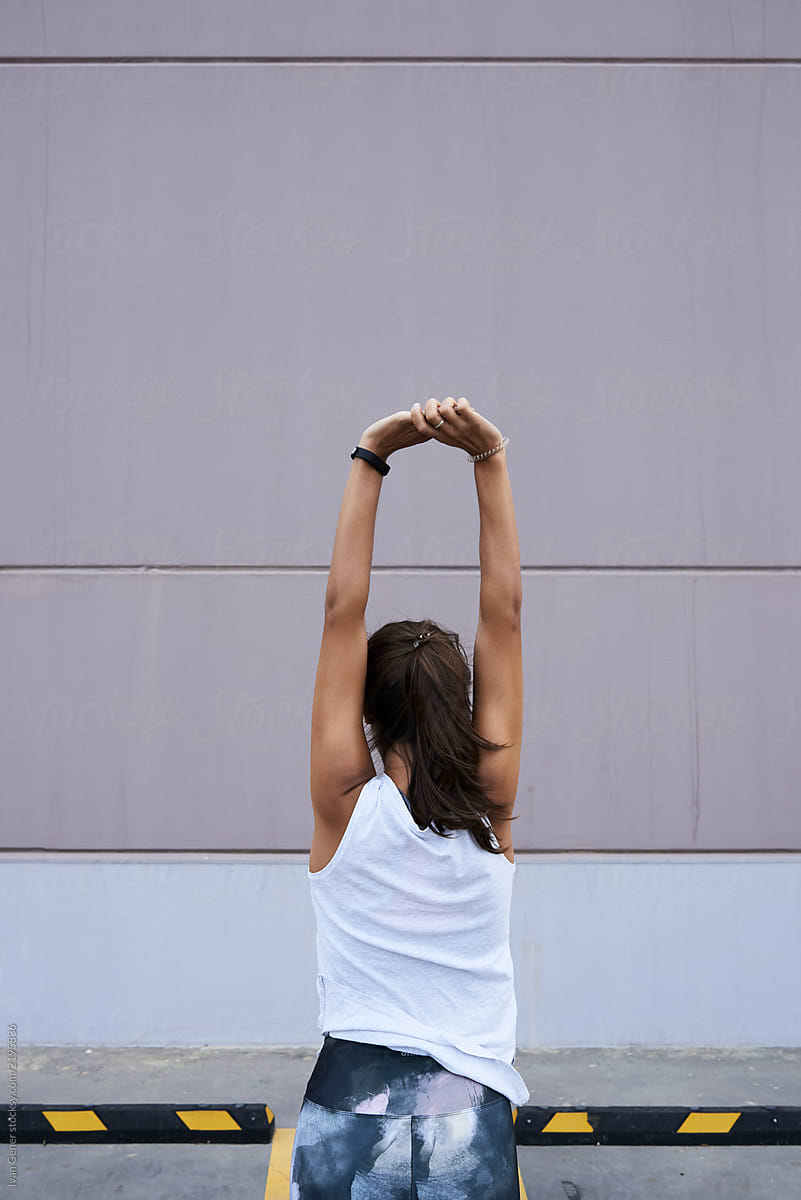 "Sportswoman Stretching Arms" by Stocksy Contributor "Ivan Gener" - Stocksy