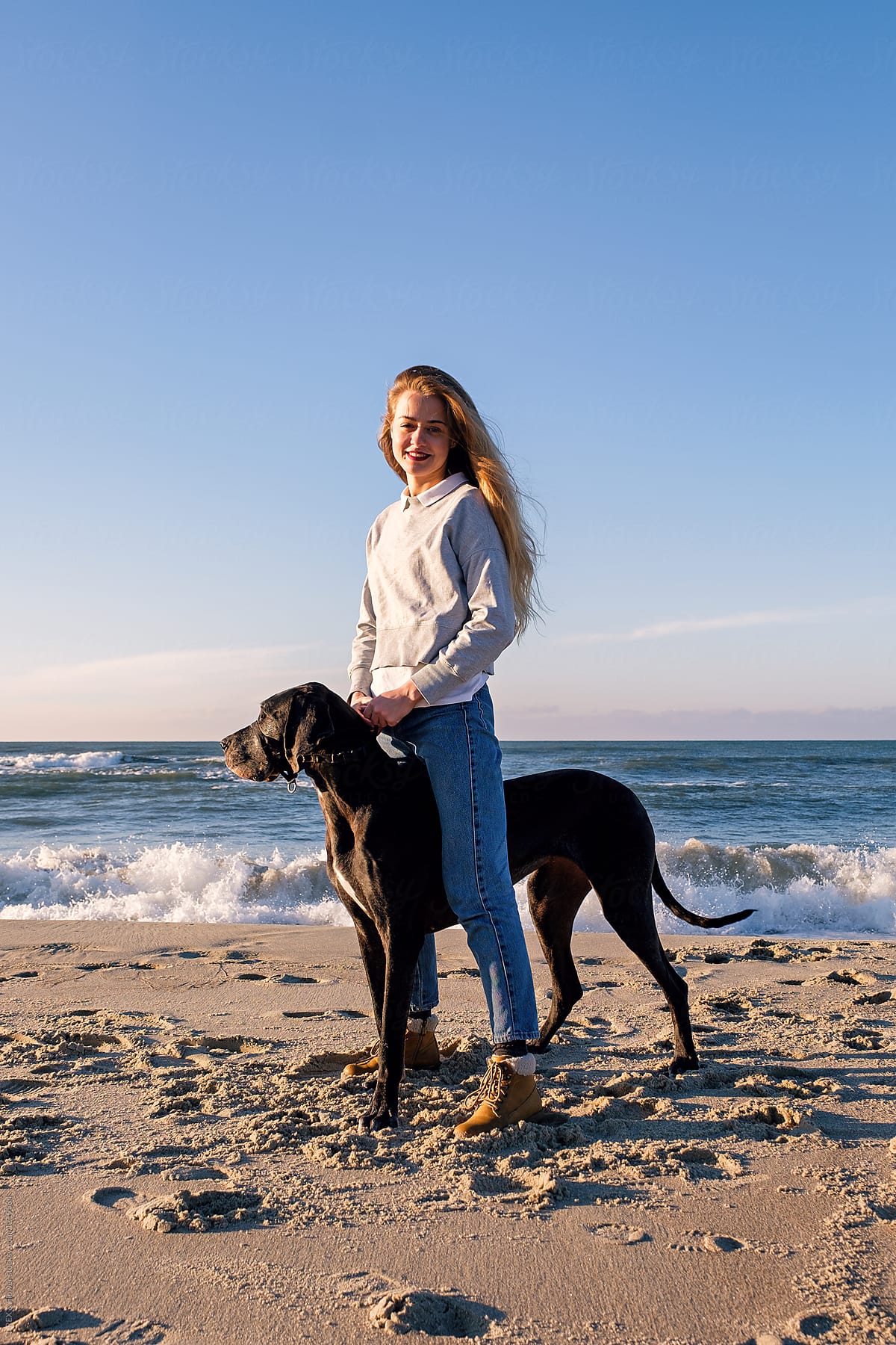 "Lady Standing Atop Her Big Black Dog" by Stocksy Contributor "Danil ...