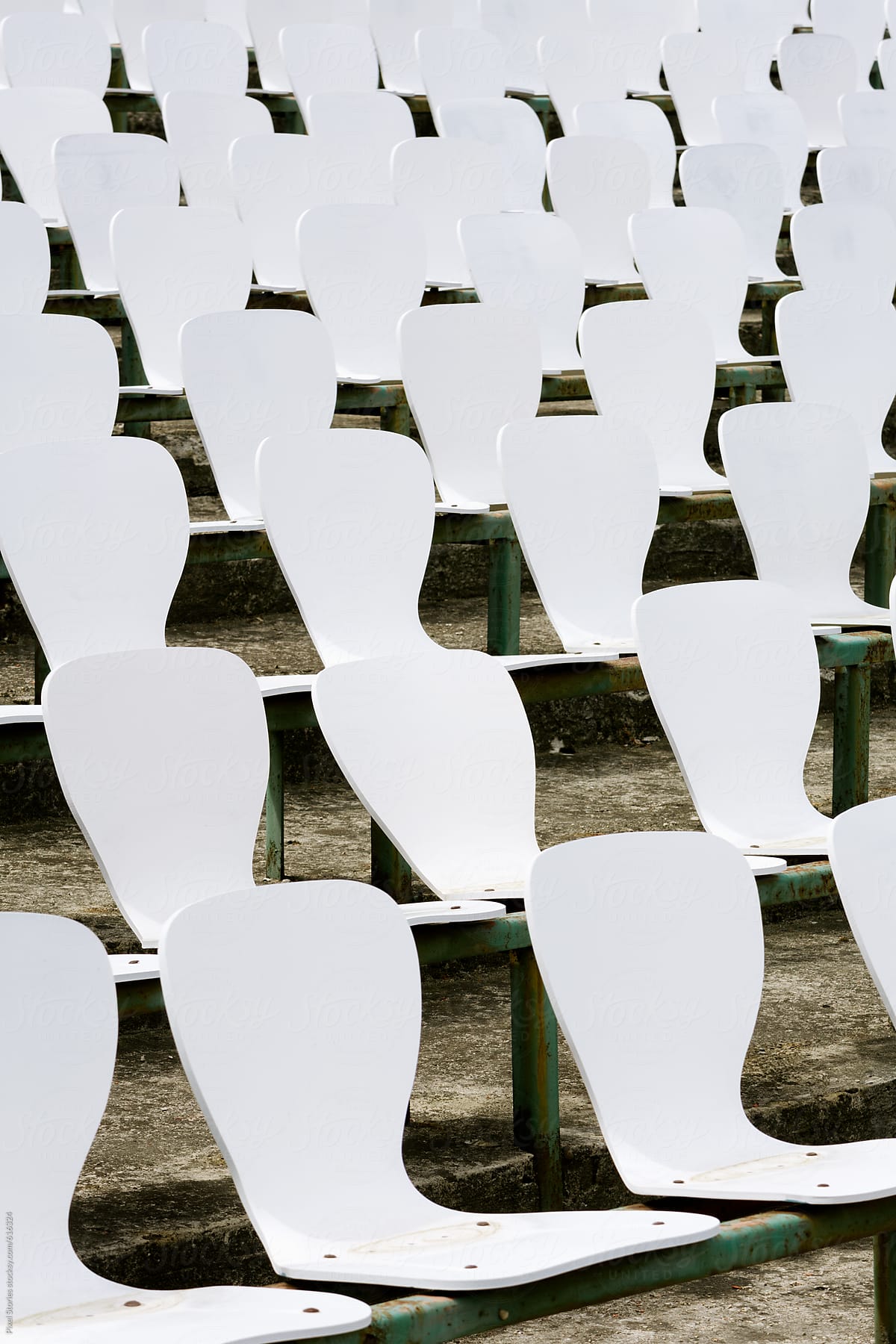 "Empty White Seats" by Stocksy Contributor "Sibila and Pavel" - Stocksy