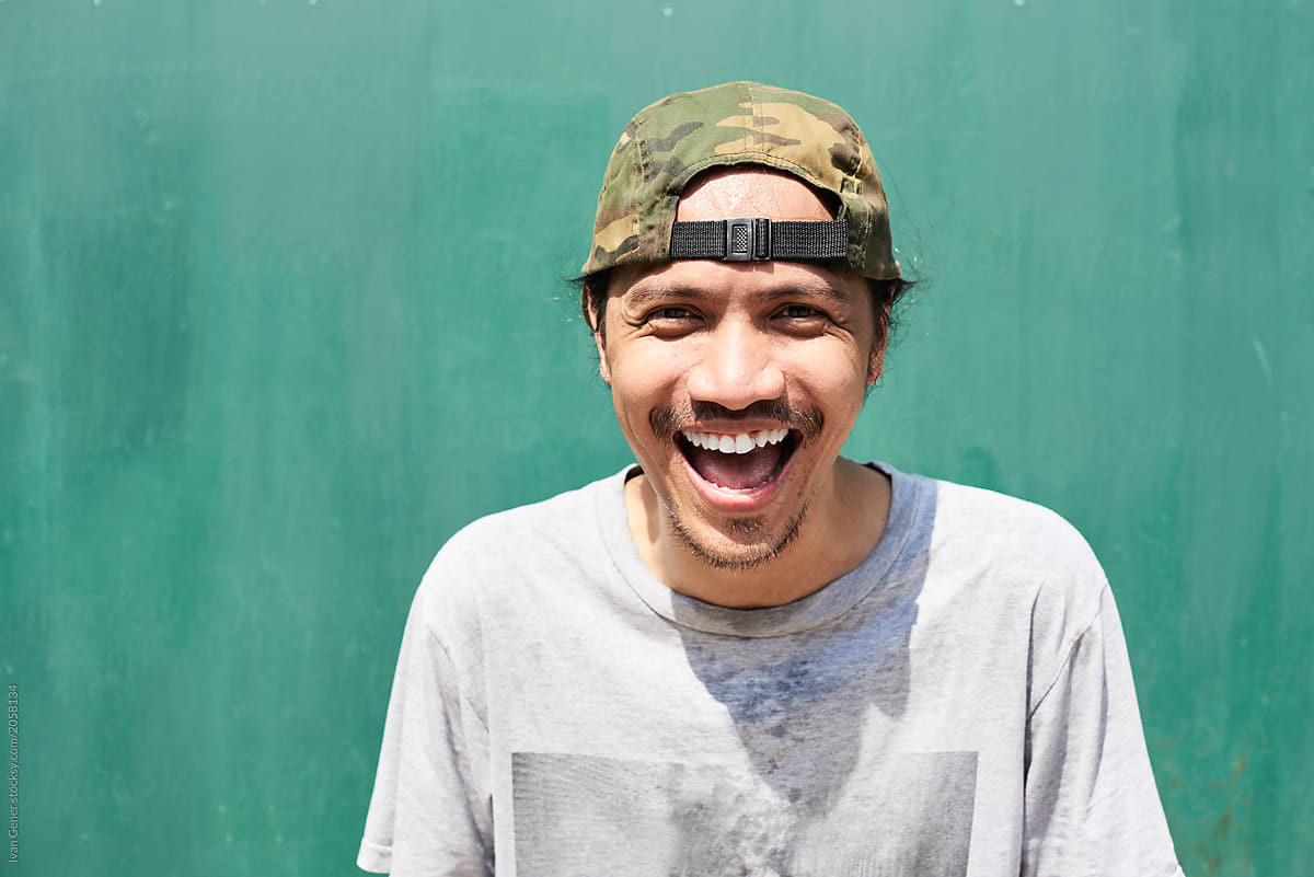 "Cheerful Muslim Male" by Stocksy Contributor "Ivan Gener" - Stocksy