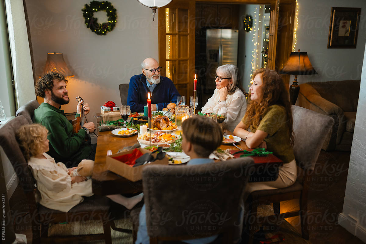 "Festive Family Dinner" by Stocksy Contributor "DZ FILM" - Stocksy