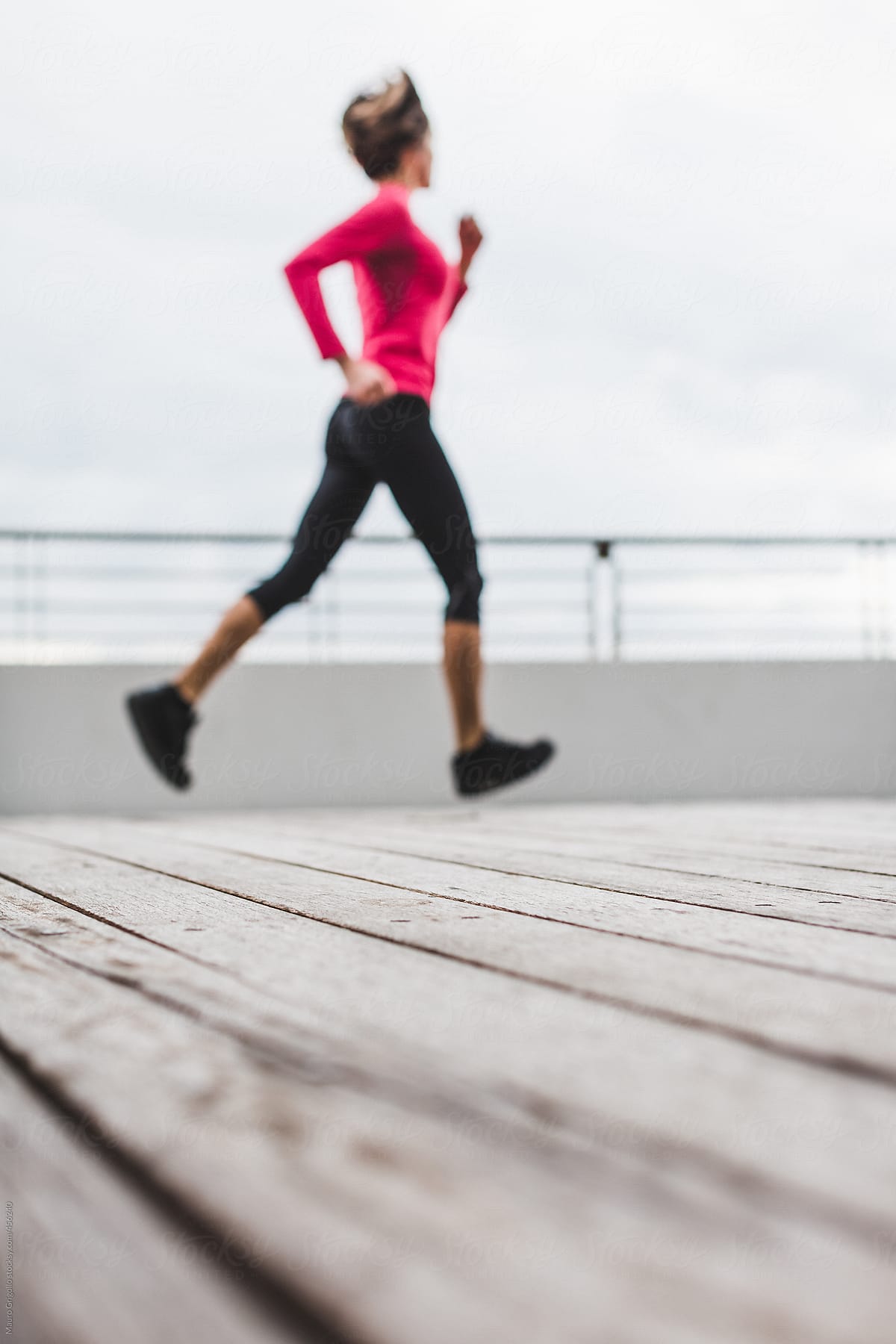 "A Girl Runs Outdoor" by Stocksy Contributor "Mauro Grigollo" - Stocksy