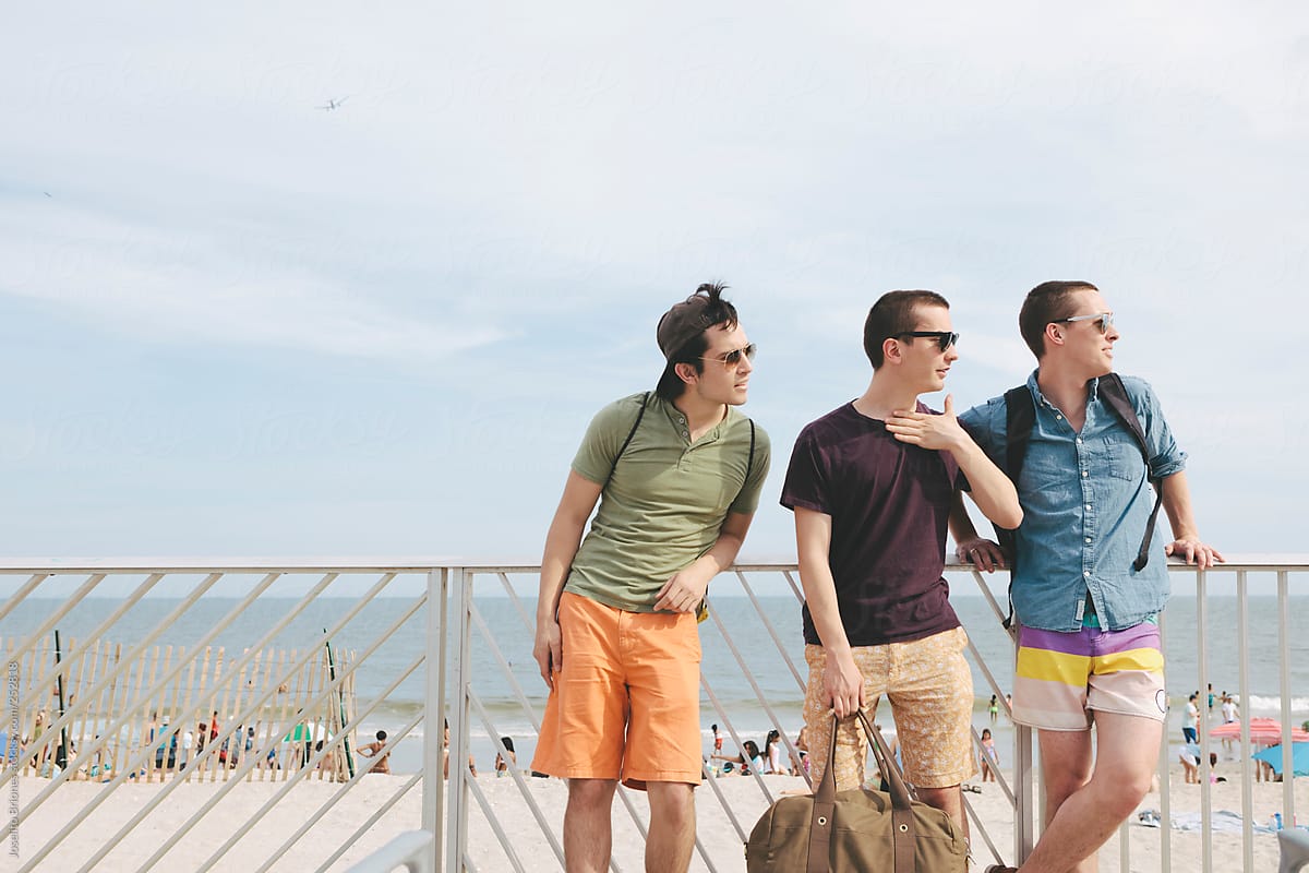 "Young Men Friends Having Fun Hanging Out In Rockaway Beach Boardwalk ...