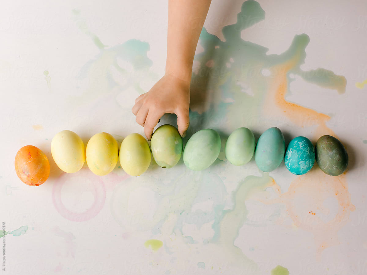 "Little Hand Grabbing Easter Egg" by Stocksy Contributor "Ali Harper ...
