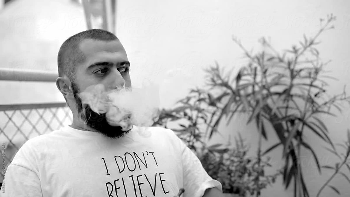 "Man Smoking Shisha" by Stocksy Contributor "MEM Studio" - Stocksy