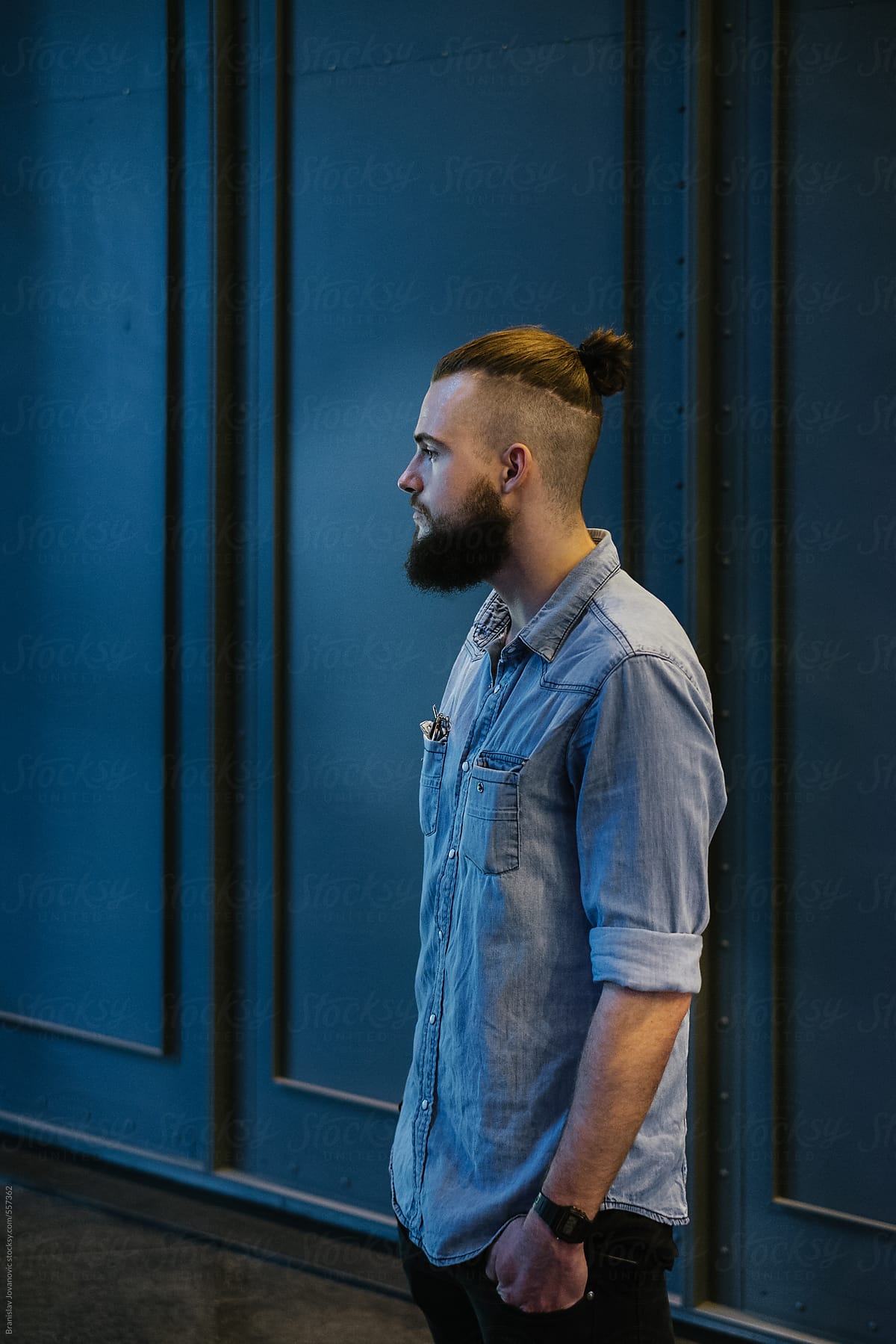 "Young Bearded Man Standing Against The Blue Wall" by Stocksy ...