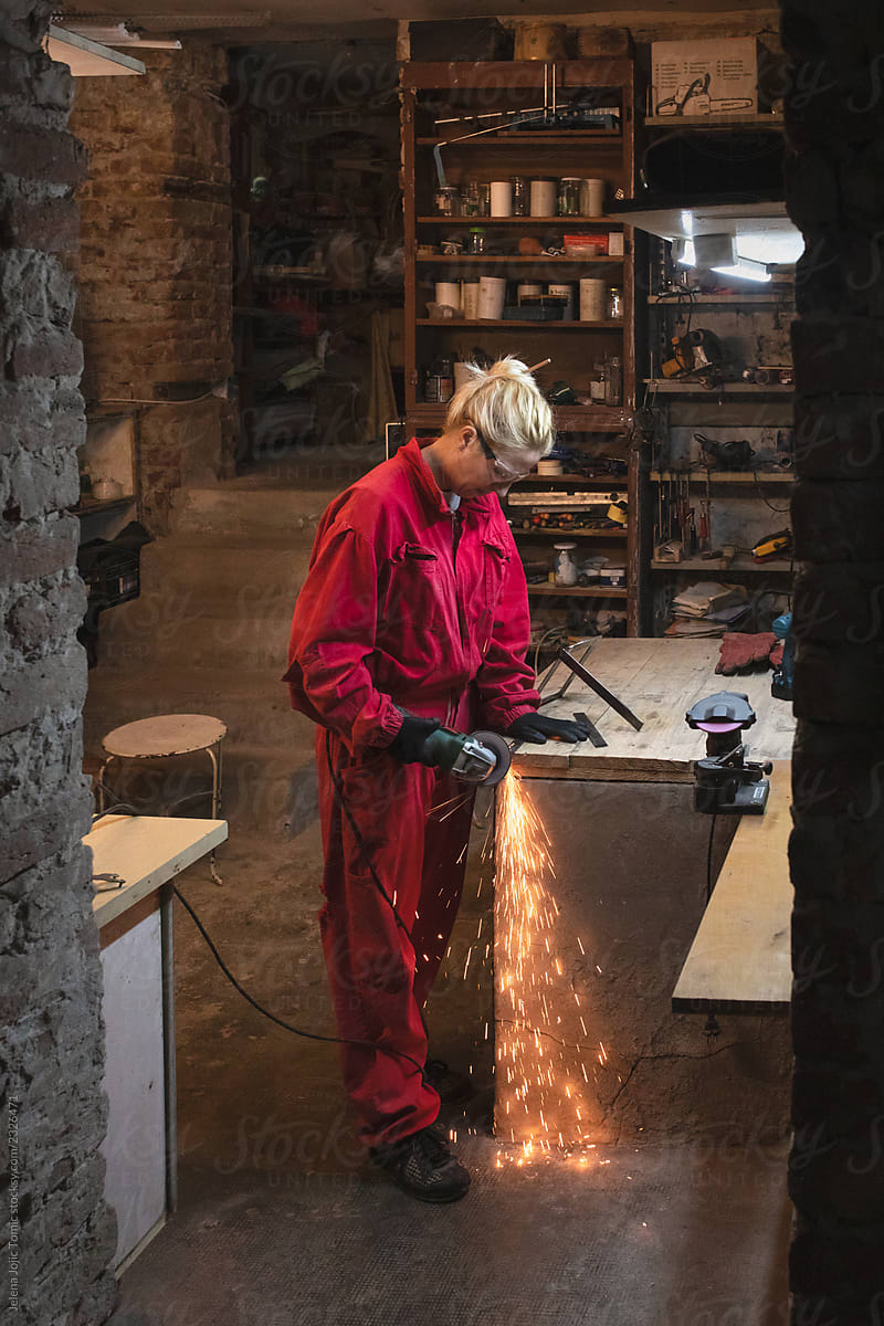 "Blonde Woman Works With Metal Grinder" by Stocksy Contributor "Jelena ...