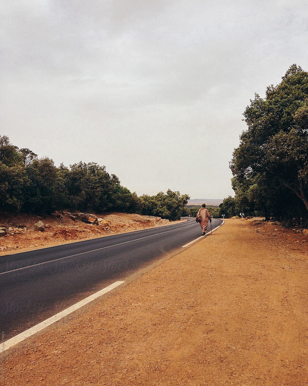 "Pilgrim Walking Along Road" by Stocksy Contributor "VISUALSPECTRUM ...