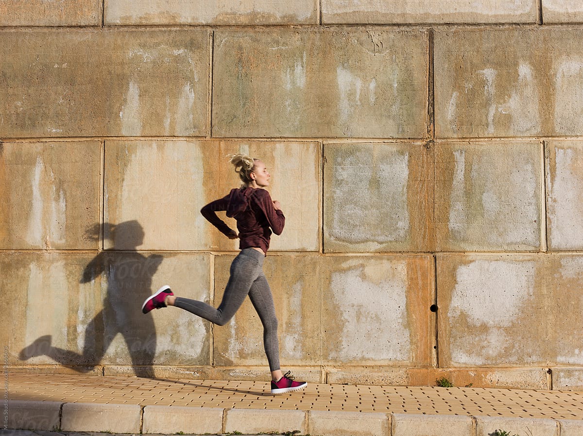 "Woman Running At Wall" by Stocksy Contributor "Milles Team" - Stocksy