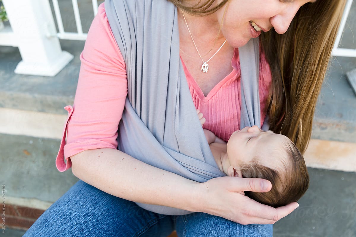 "Baby Wearing Mother Cups Head Of Infant In Her Hand" by Stocksy ...