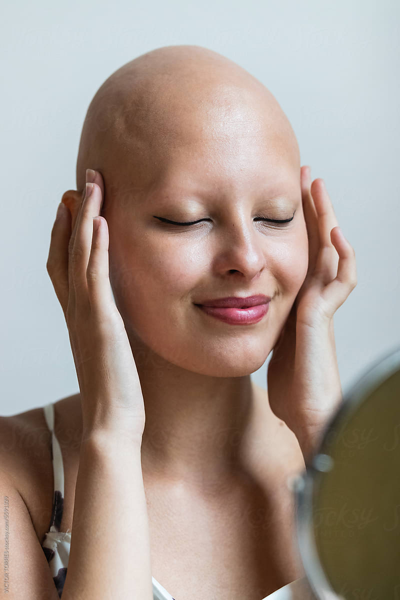 "Confident Young Bald Woman Smiling And Looking In Mirror" by Stocksy ...