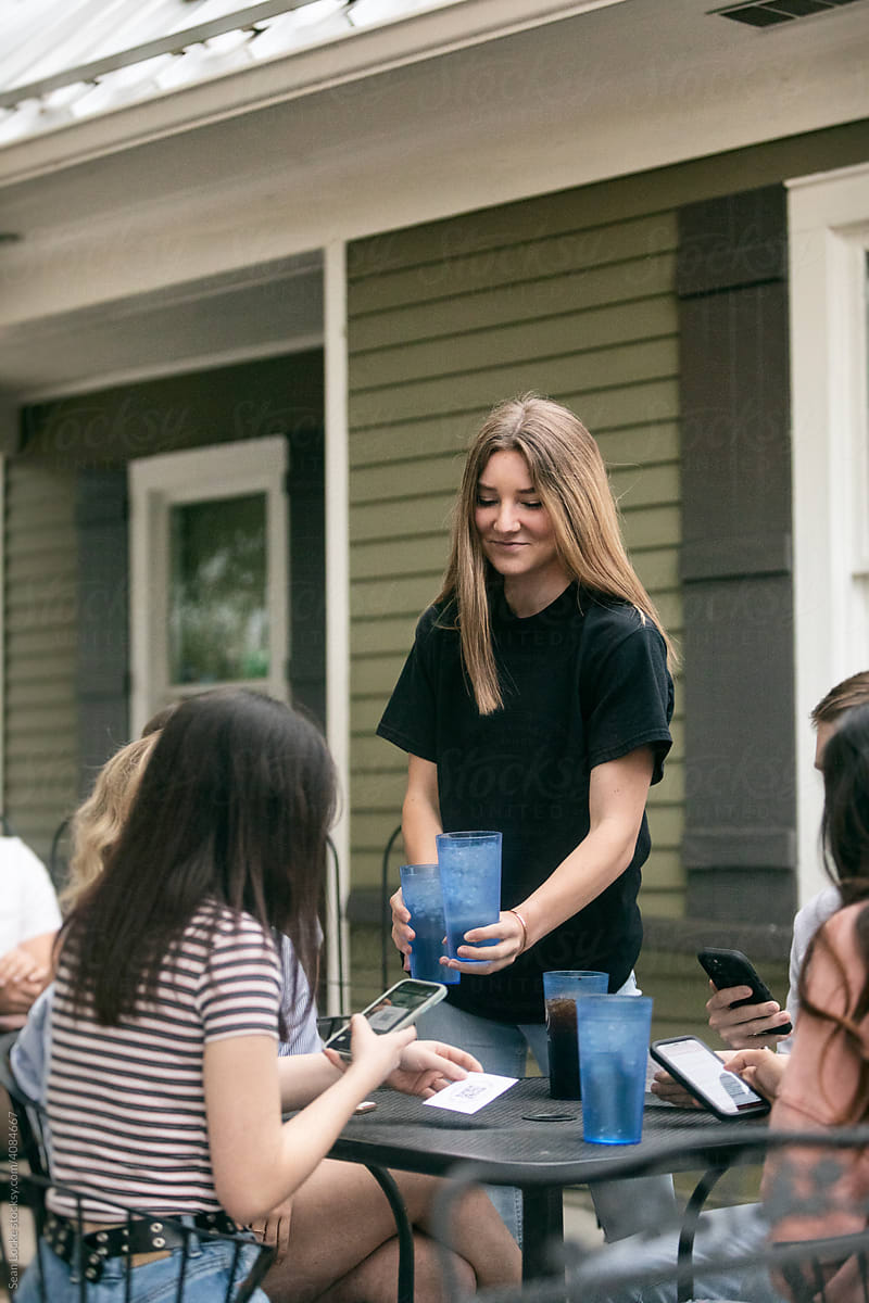 "Dining: Server Brings Drinks To Table" by Stocksy Contributor "Sean ...