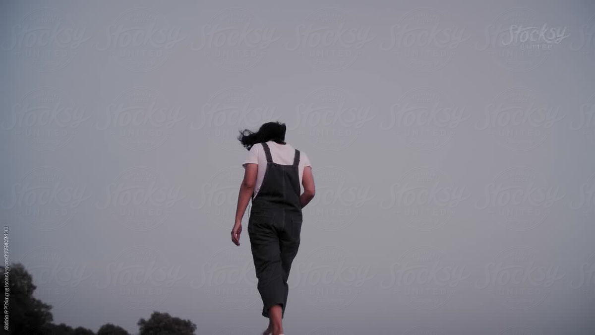 "Young Woman Walking Along A Wall" by Stocksy Contributor "Adrian P ...