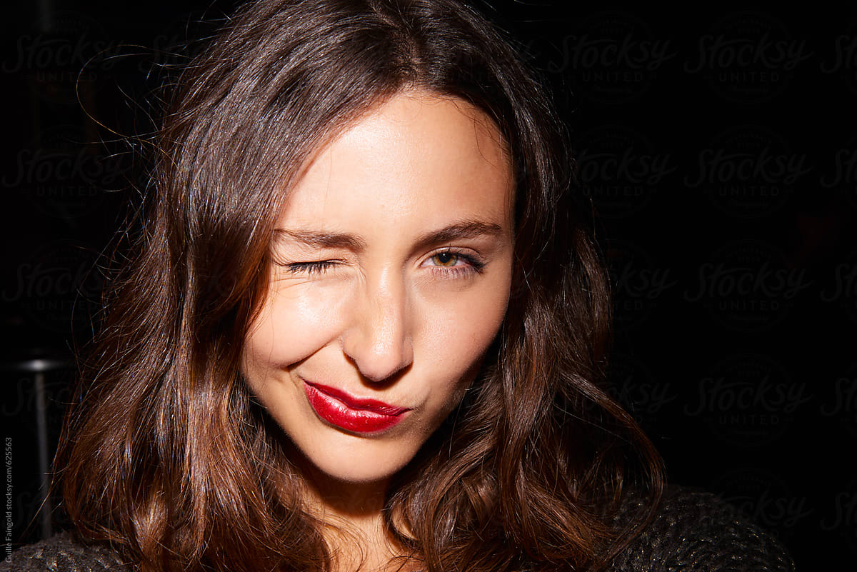 "Girl Winking" by Stocksy Contributor "Guille Faingold" - Stocksy
