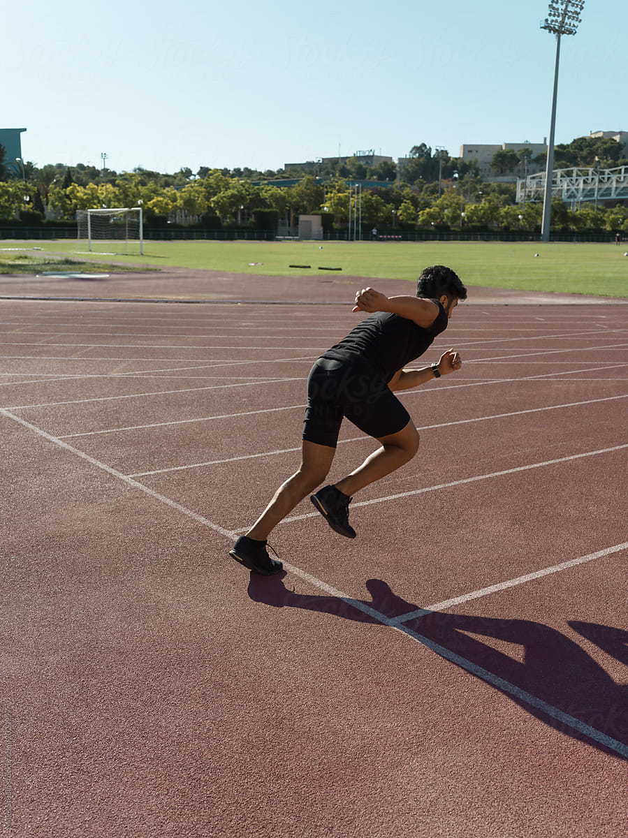 "Man Speeds Off On stadium" by Stocksy Contributor "Milles Team" - Stocksy