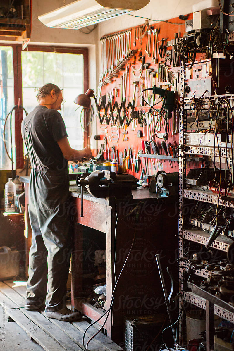 "Mechanic Working In Old Workshop." by Stocksy Contributor "AUDSHULE ...