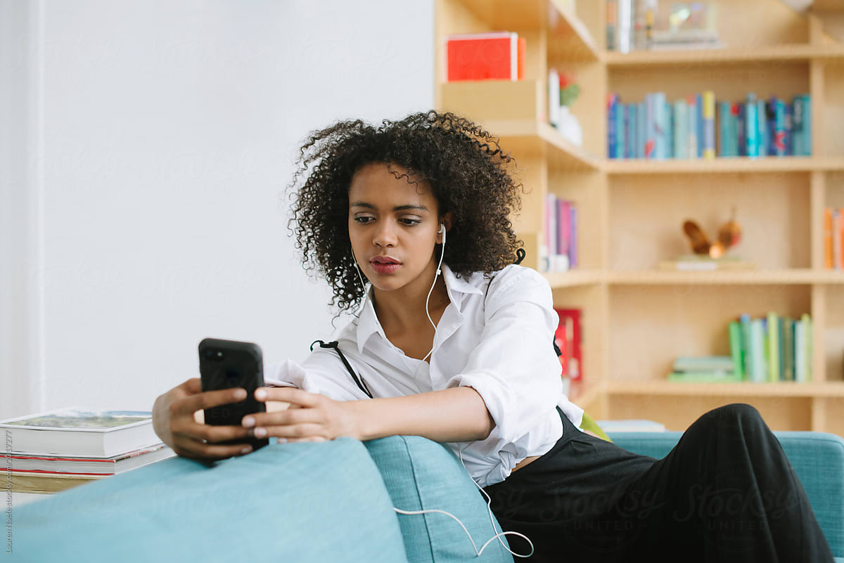 "Young Woman On Phone At Home" by Stocksy Contributor "Lauren Lee ...